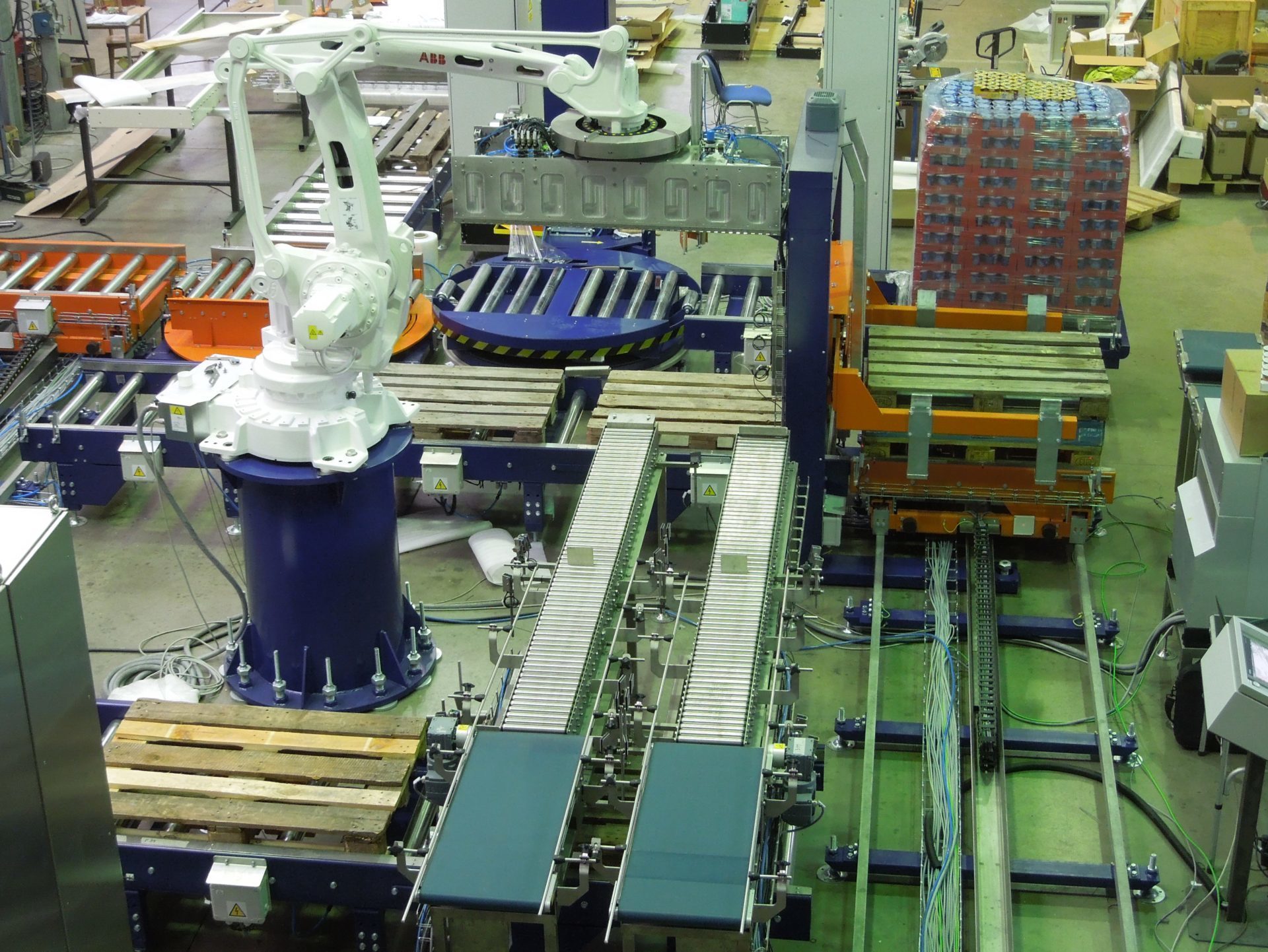 Robotic palletization with wrapper and conveyors - Atrima spol. s r.o.